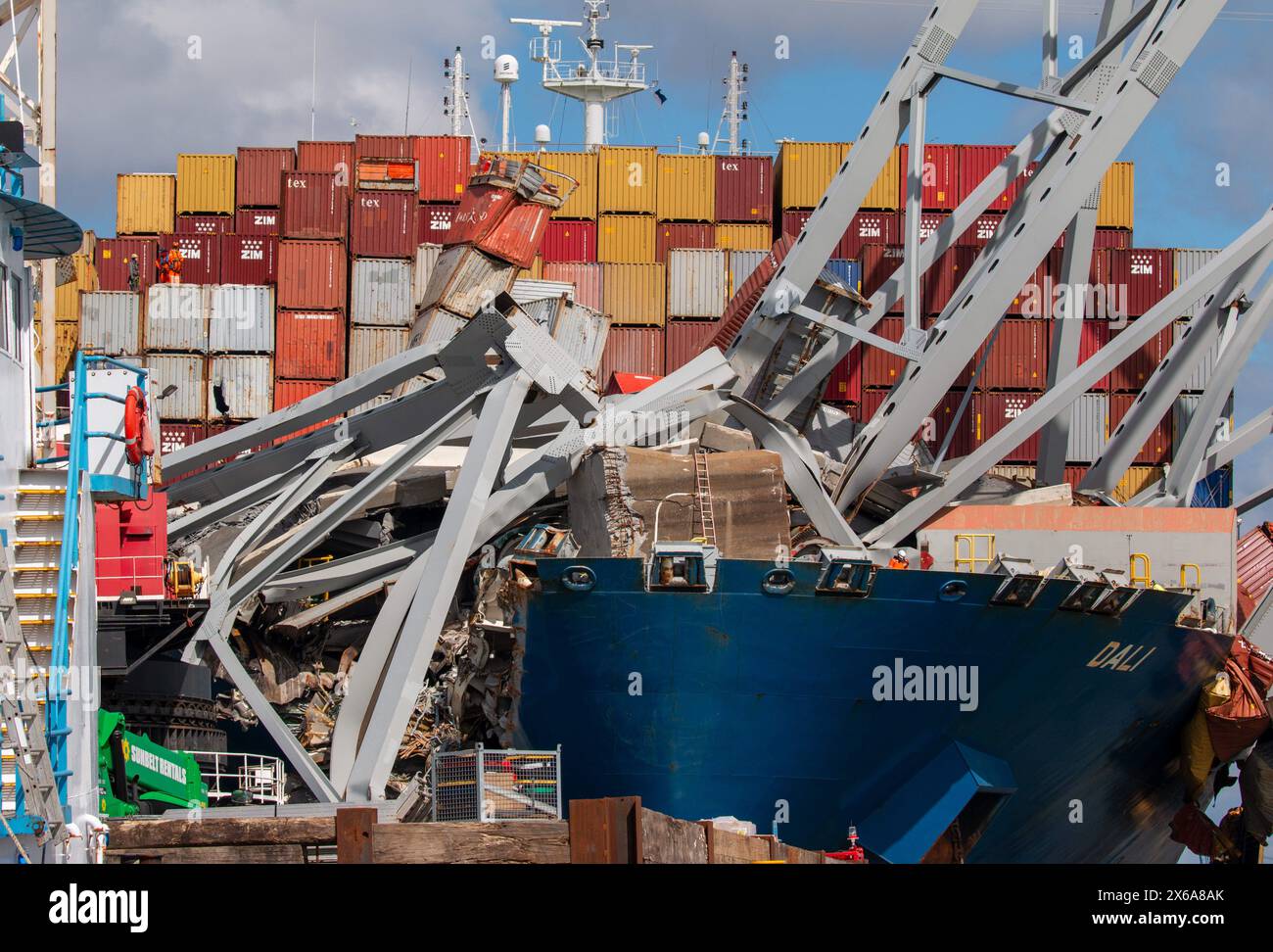 A salvage team works atop several containers on the M/V Dali on April 6 ...