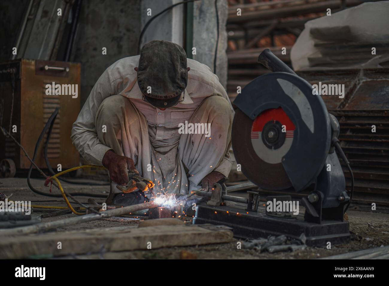 Poor old skilled Pakistani Welder welding pipes and metal rods in his ...