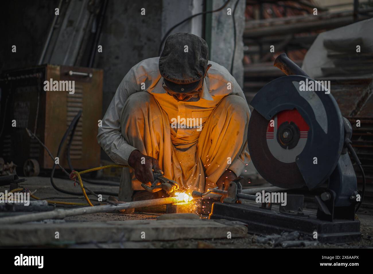 Poor old skilled Pakistani Welder welding pipes and metal rods in his ...