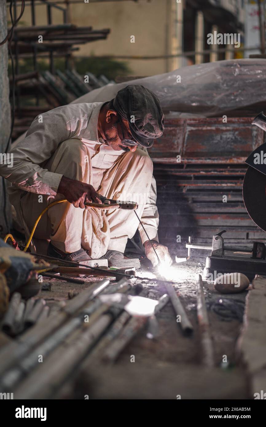 Poor old Pakistani Welder welding pipes and metal rods in his street ...