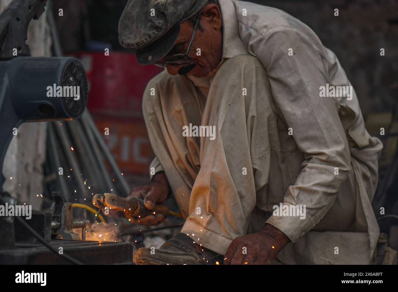 Poor old skilled Pakistani Welder welding pipes and metal rods in his ...