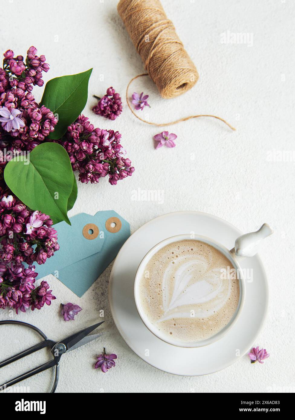 Cup of coffee with heart latte art with lilac flowers Stock Photo - Alamy
