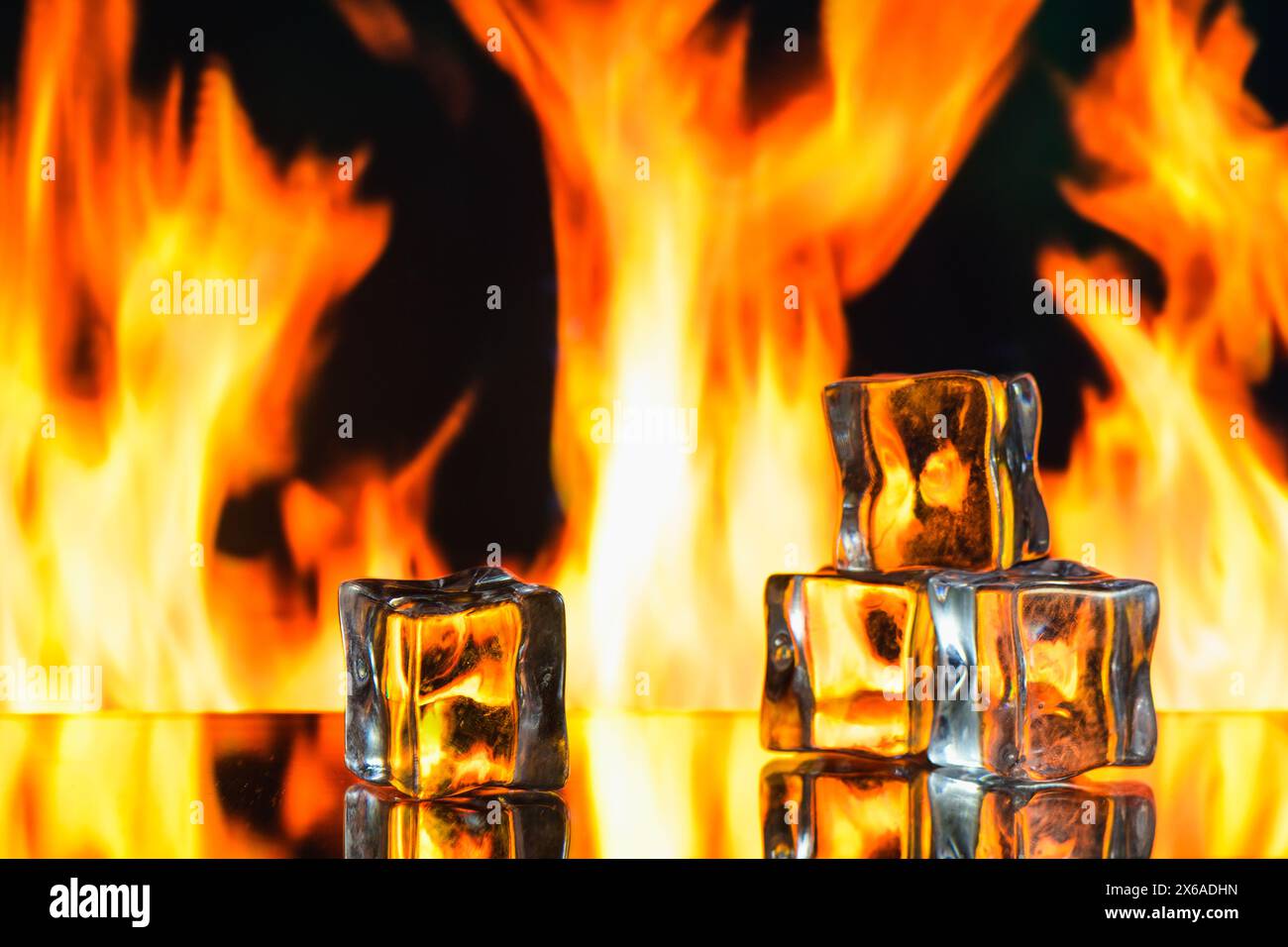 three ice cubes against the background of fire, fire and ice, place ...
