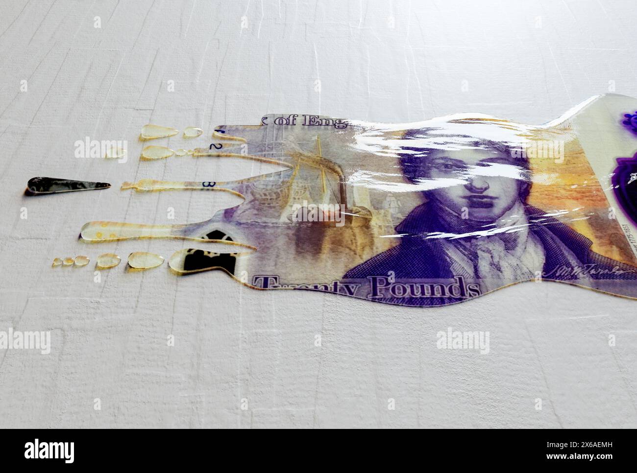 A concept image showing a regular British pound banknote that is melted ...