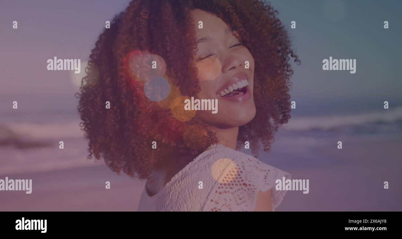 Image of lens flares over portrait of biracial young woman with afro ...