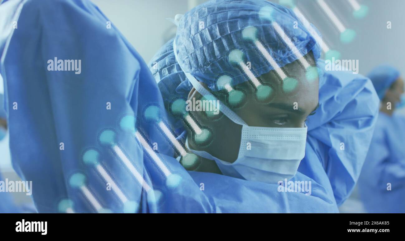 Image of dna strand over diverse doctors with face masks during surgery ...