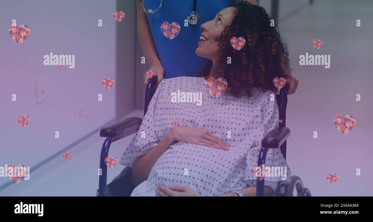 Image of heart icons over happy biracial pregnant woman talking with ...