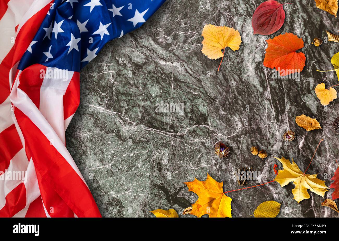 USA flag buried in yellow dry leaves. Autumn texture Stock Photo - Alamy