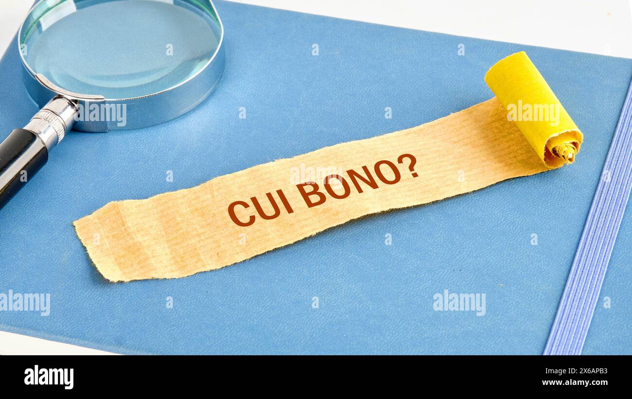 CUI BONO (to whose benefit) question on a note made of paper on a blue ...