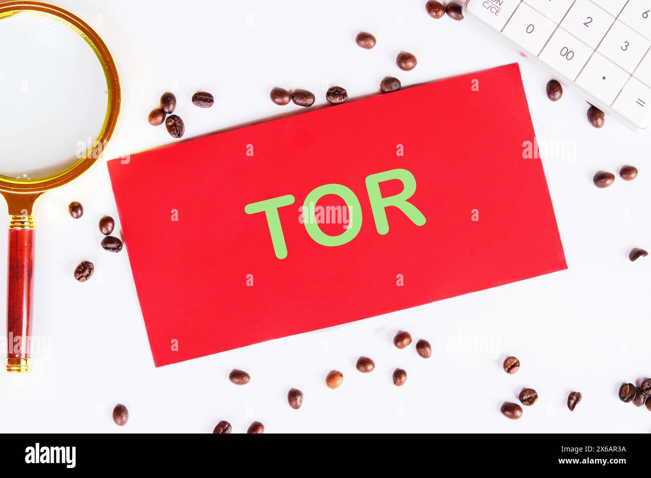 TOR Terms Of Reference on red paper on a white background with coffee ...