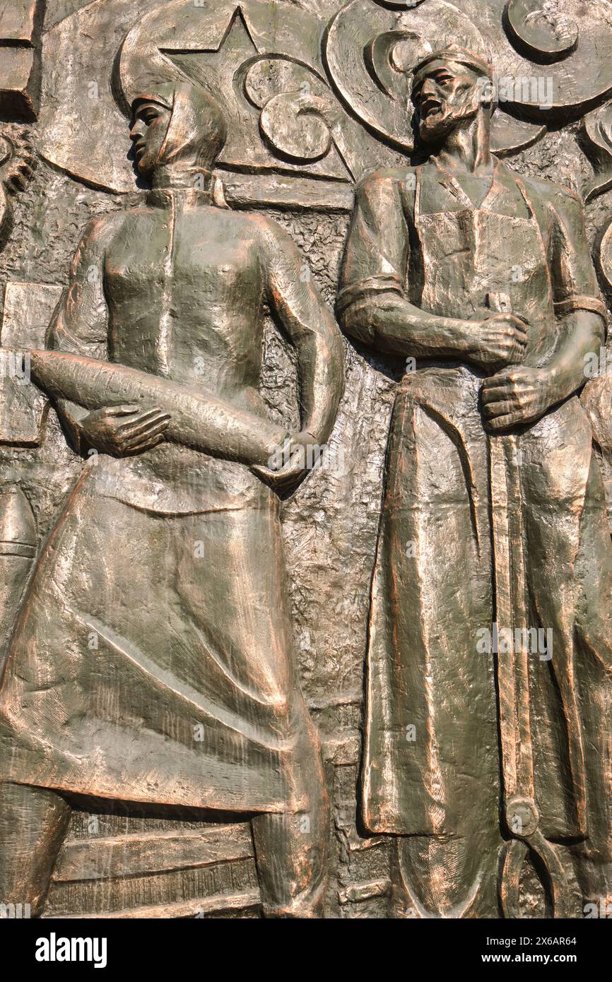 Workers at a bomb, munitions factory. View of the main bronze frieze at the Soviet Great ...