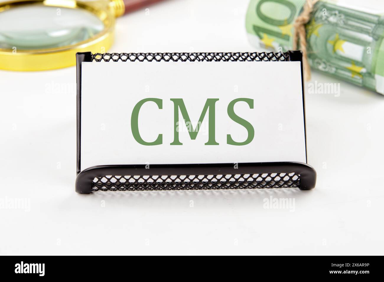 CMS (Custom Management System) written on a white card on a white ...