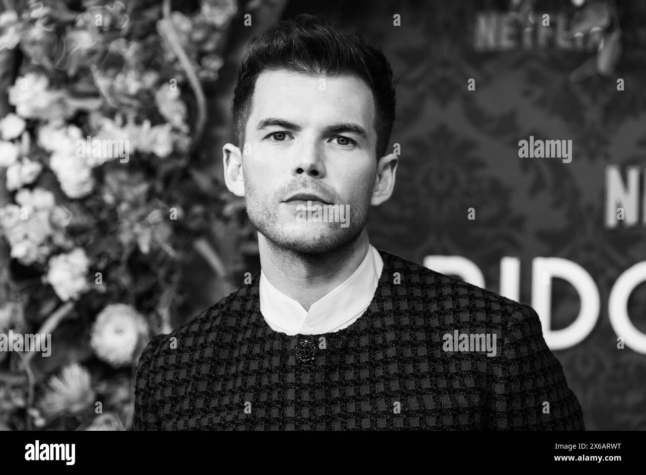 Luke Newton wearing dress by Versace and wrist watch by Chopard attends ...