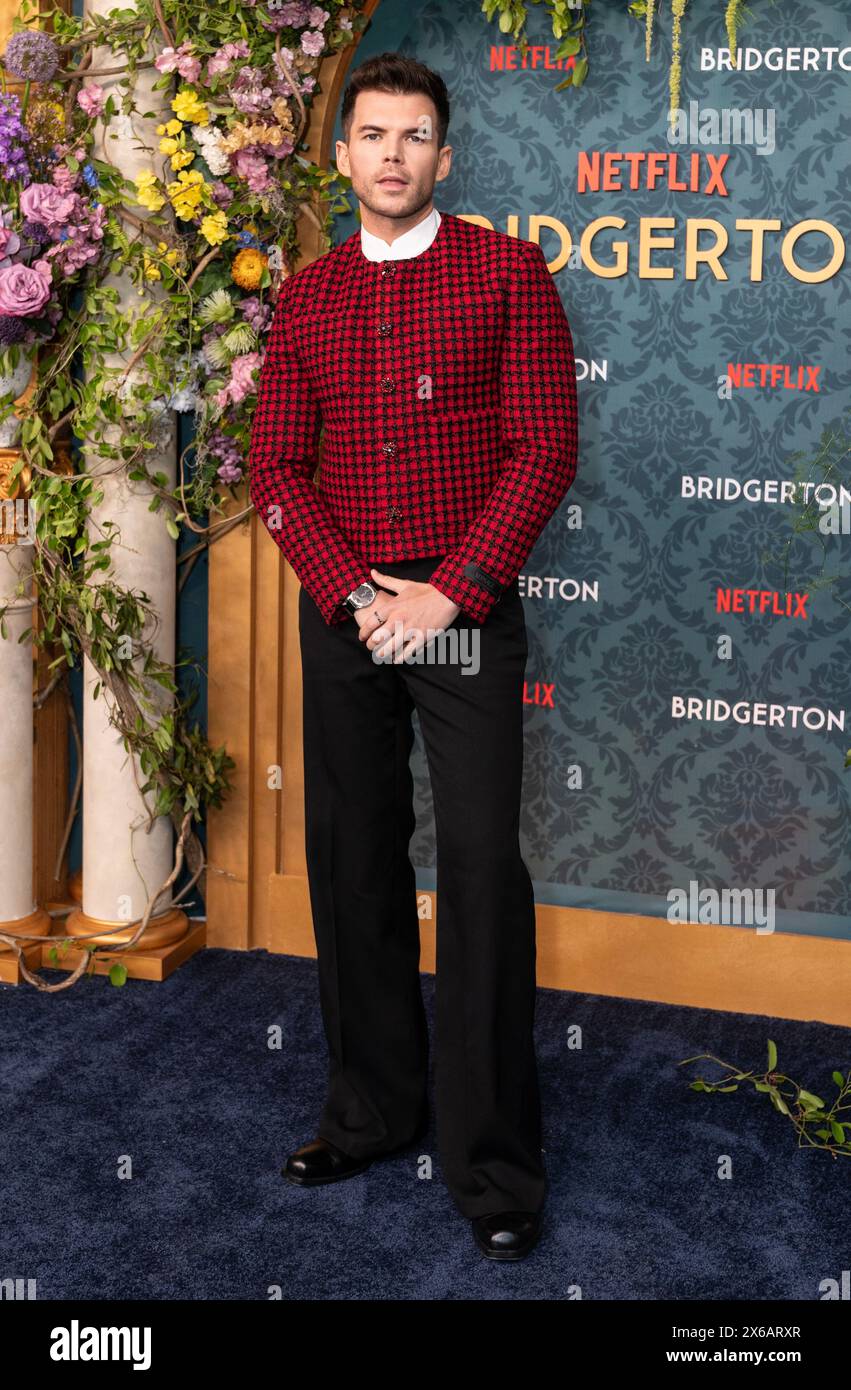 Luke Newton wearing dress by Versace and wrist watch by Chopard attends ...