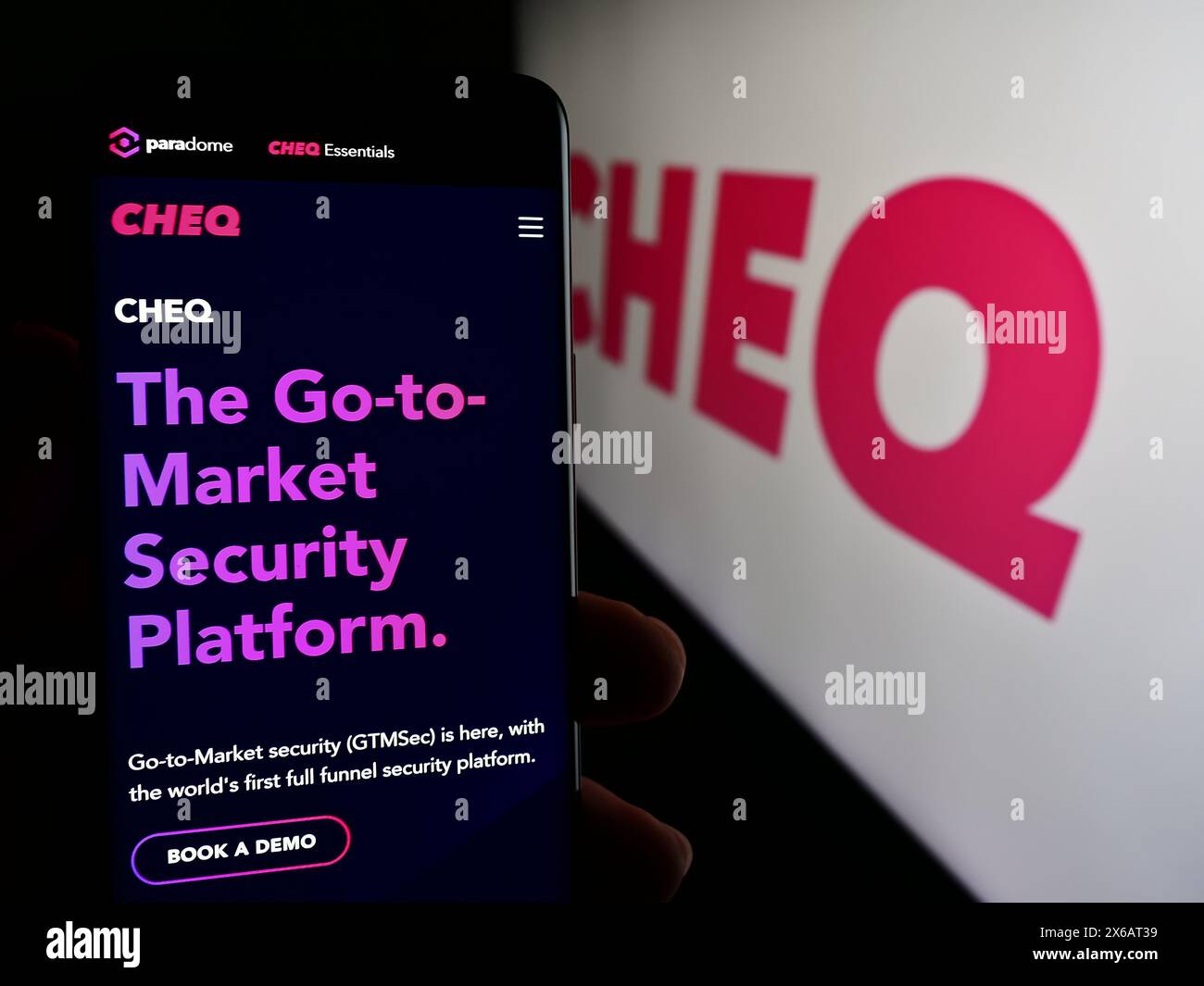 Person holding smartphone with web page of US cybersecurity company ...