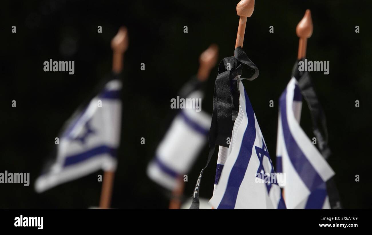 JERUSALEM - MAY 12: Israeli national flags with black mourning ribbons ...
