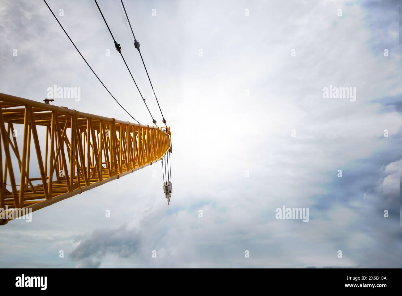 about the boom hoisting of crane at construction site and blue sky by ...