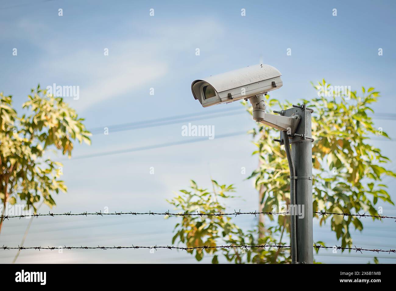 Barbed fences and spy cameras for safety Stock Photo - Alamy
