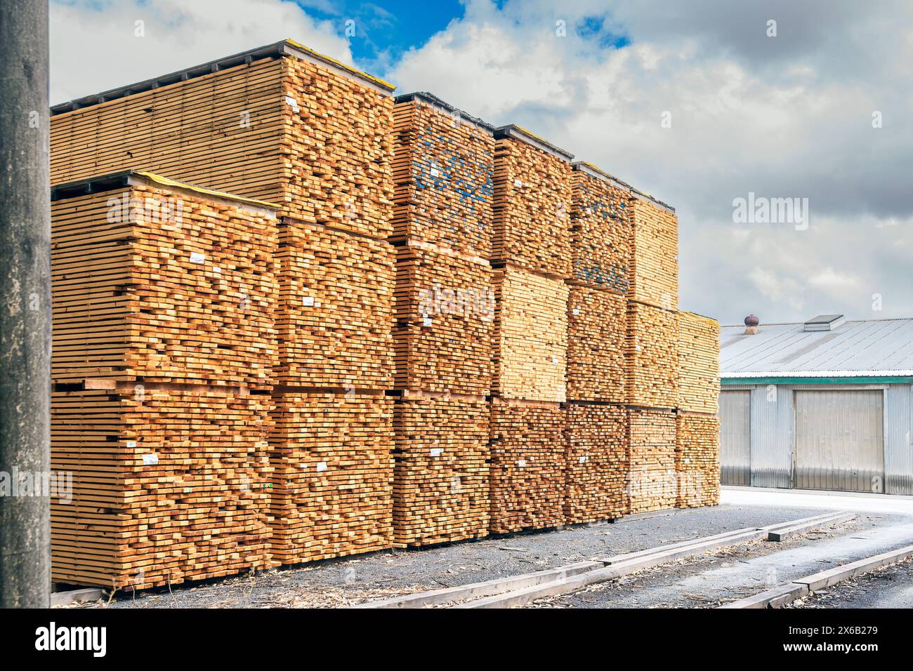 Outdoor timber warehouse with wood plank stacks ready for shipping in ...