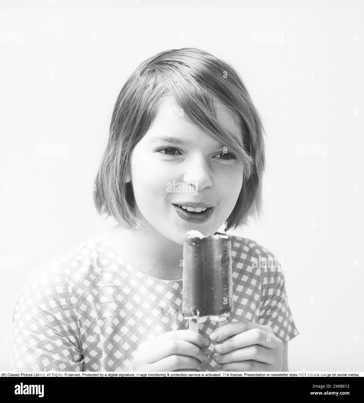 Ice cream in the 1960s. A young girl is eating ice cream bar. 1961 ...