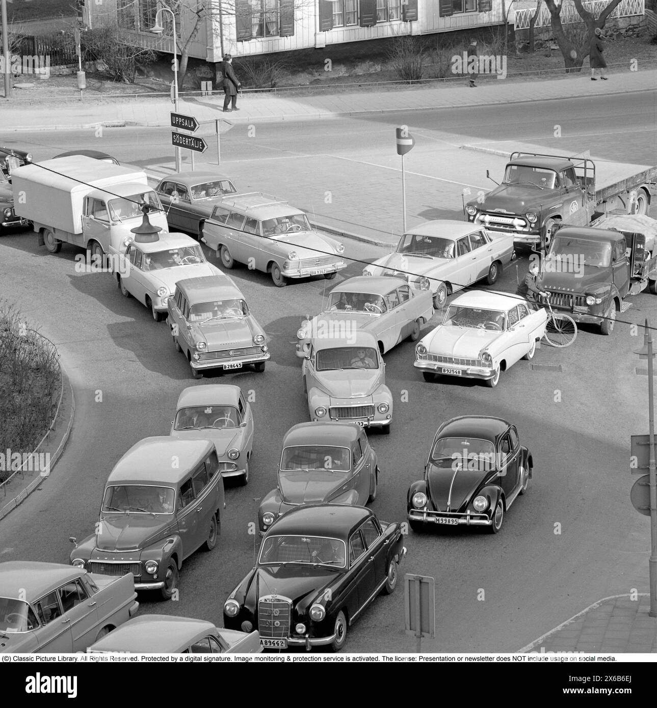 Driving in the 1960s. An intersection where cars coming from different ...
