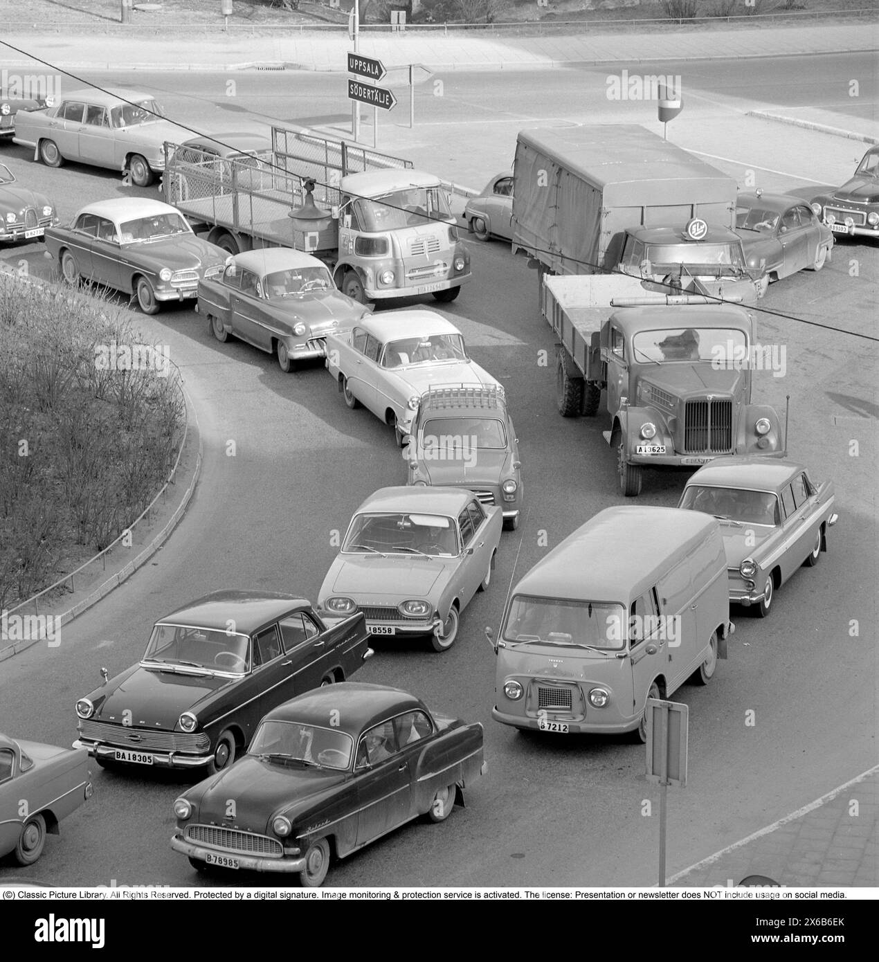 Driving in the 1960s. An intersection where cars coming from different ...