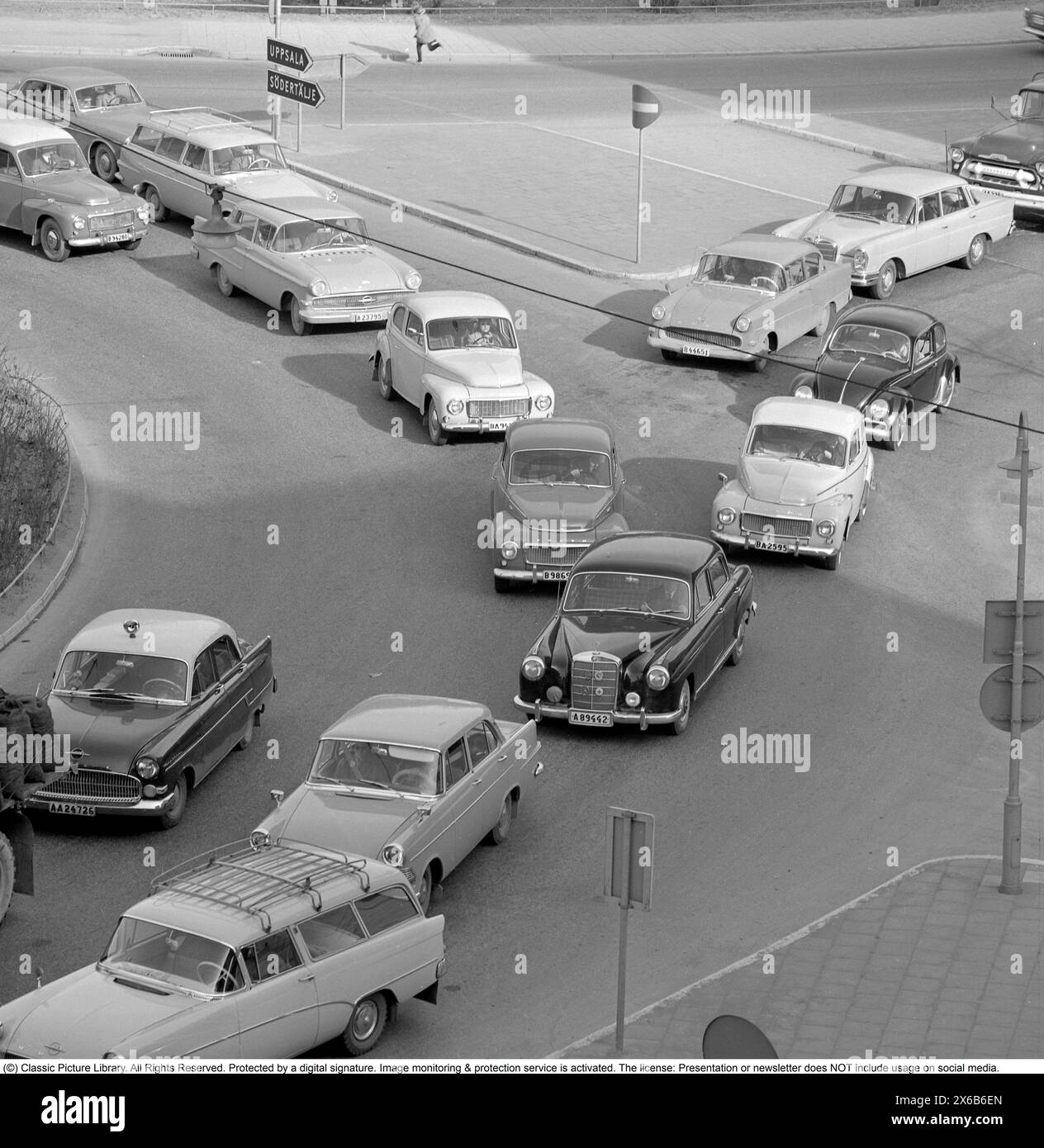Driving in the 1960s. An intersection where cars coming from different ...
