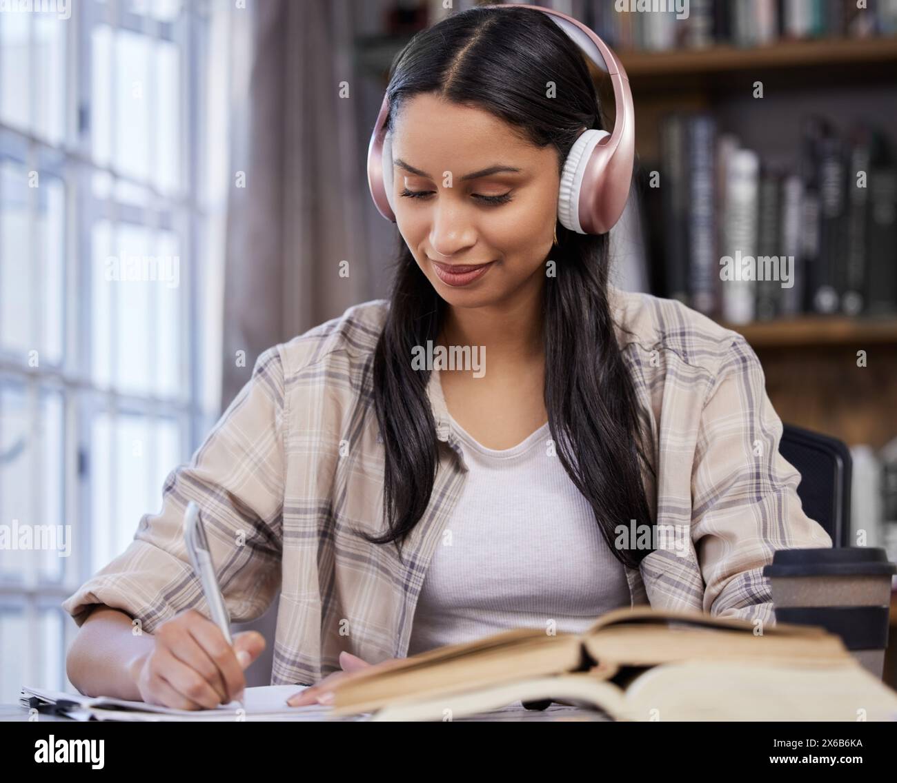 Headphones, study and girl with notebook in library for music, learning ...