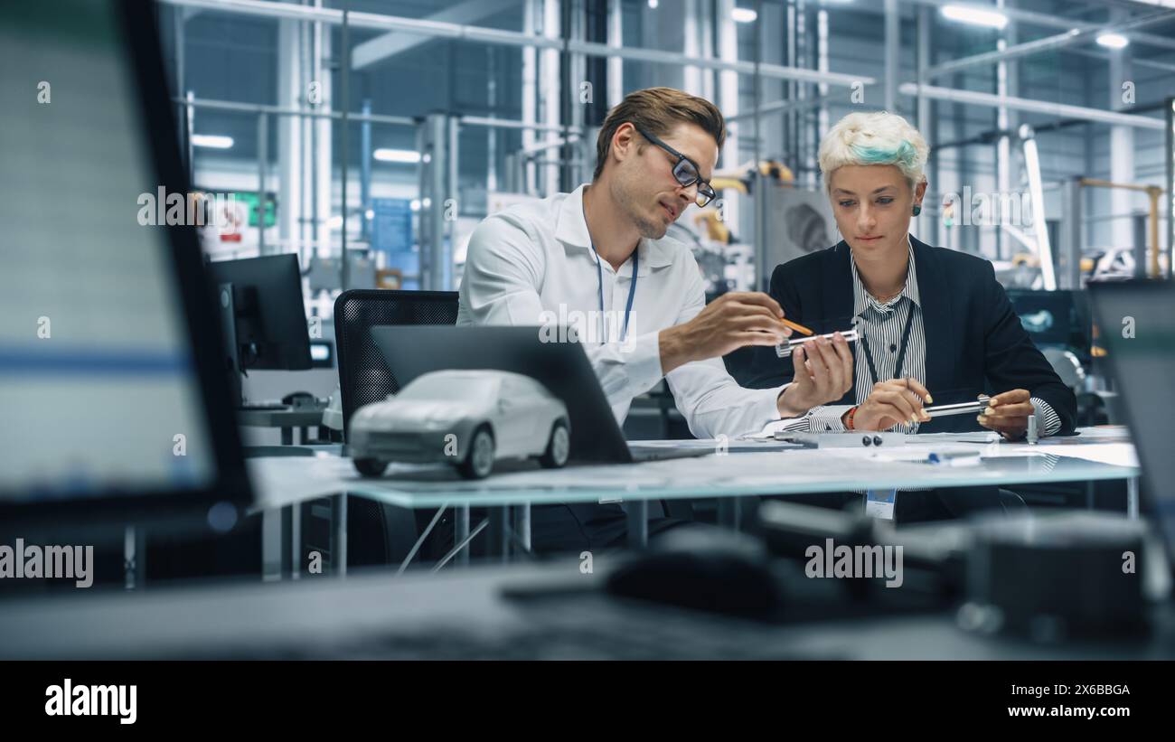 Two Young Automotive Engineers Working in Office at Car Factory ...
