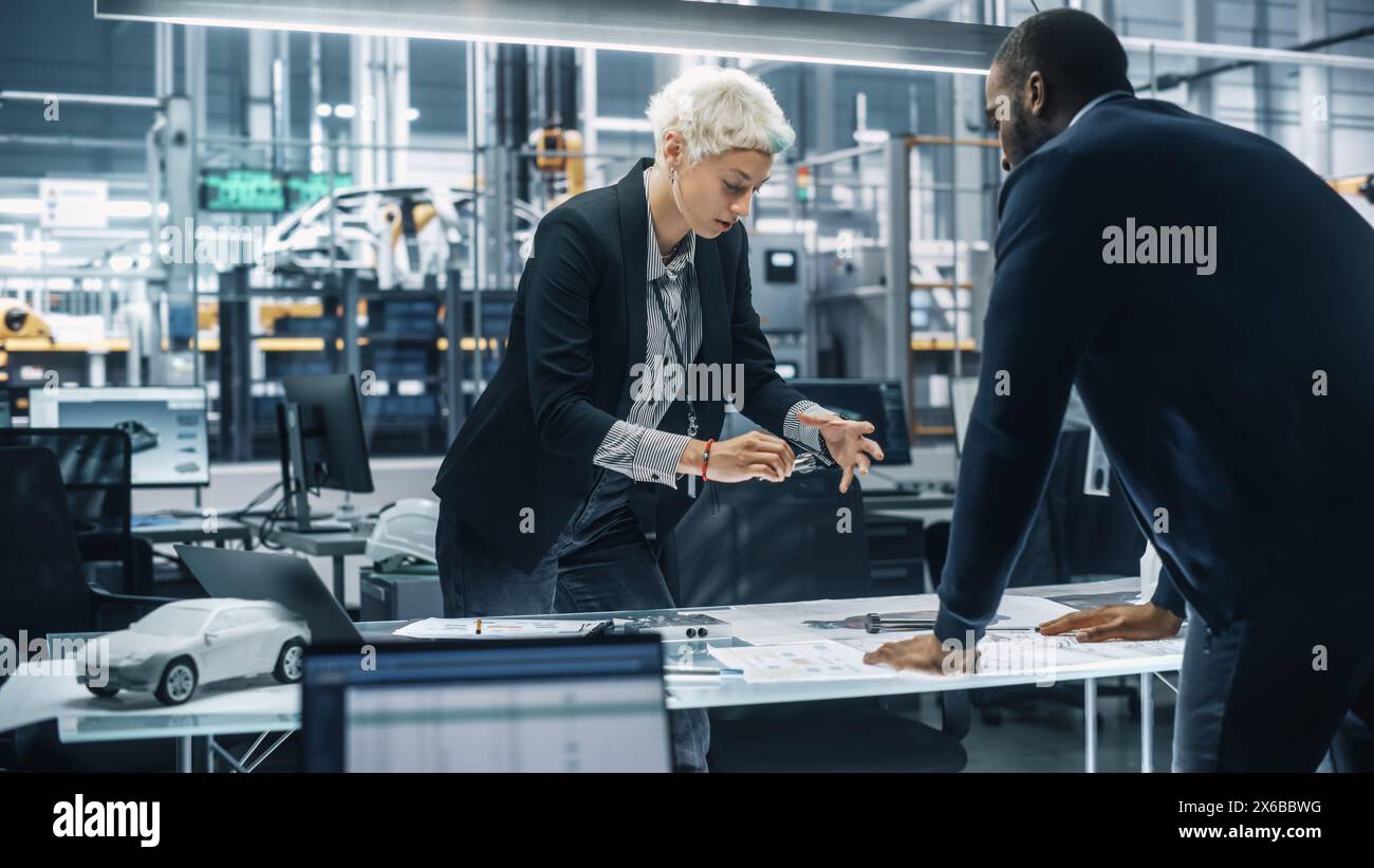 Two Young Automotive Engineers Working in Office at Car Factory ...