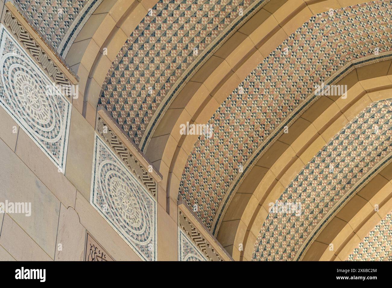 The mosque’s facade, a tapestry of stone and faith, carved with the ...