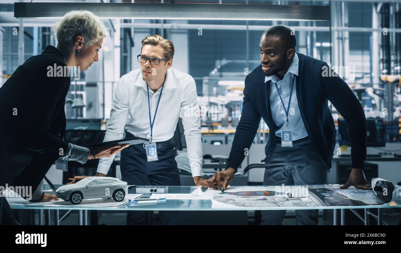 Young Diverse Team of Automotive Engineers Working in Office at Car ...