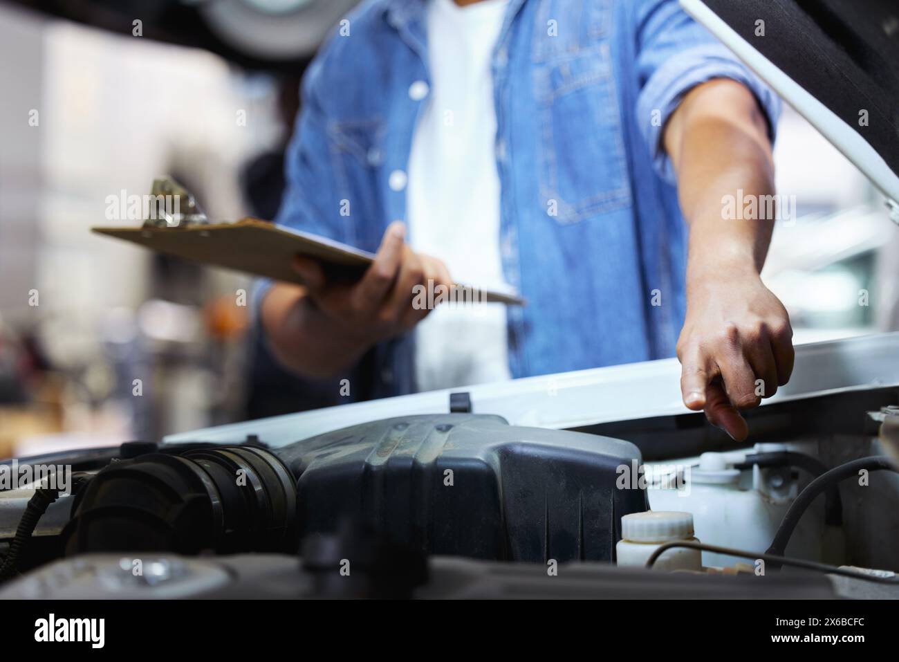 Hands, man and mechanic with car inspection, clipboard and documents ...