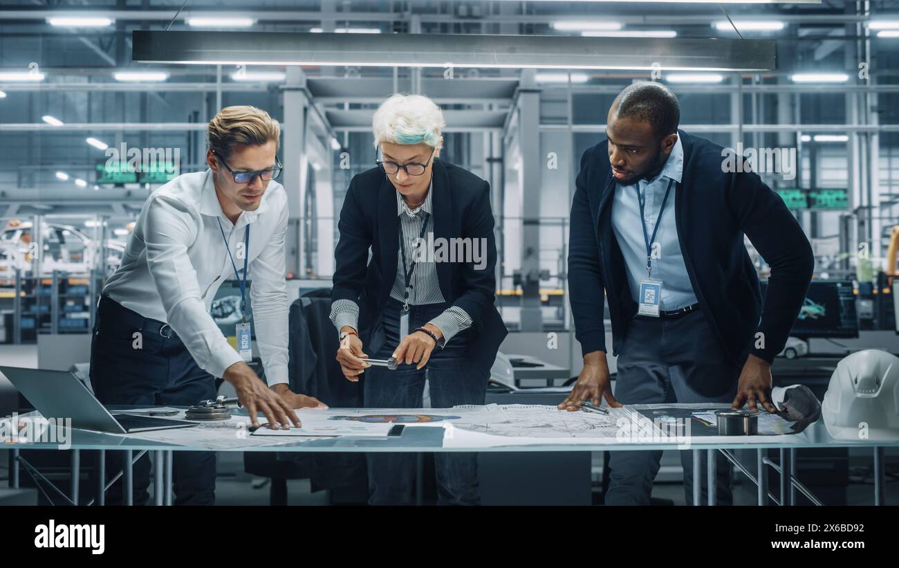 Young Diverse Team of Automotive Engineers Working in Office at Car Factory. Industrial Designer ...