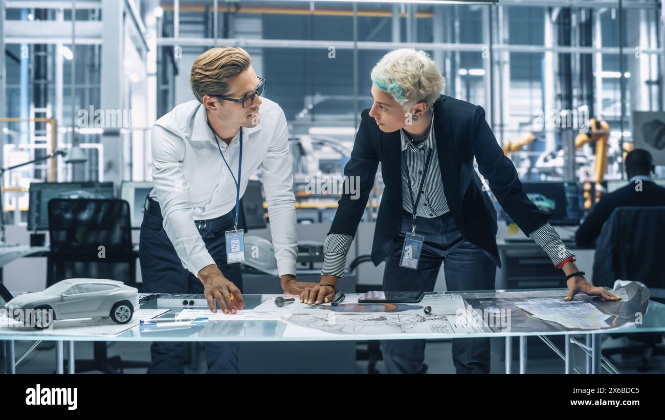 Two Young Automotive Engineers Working in Office at Car Factory ...