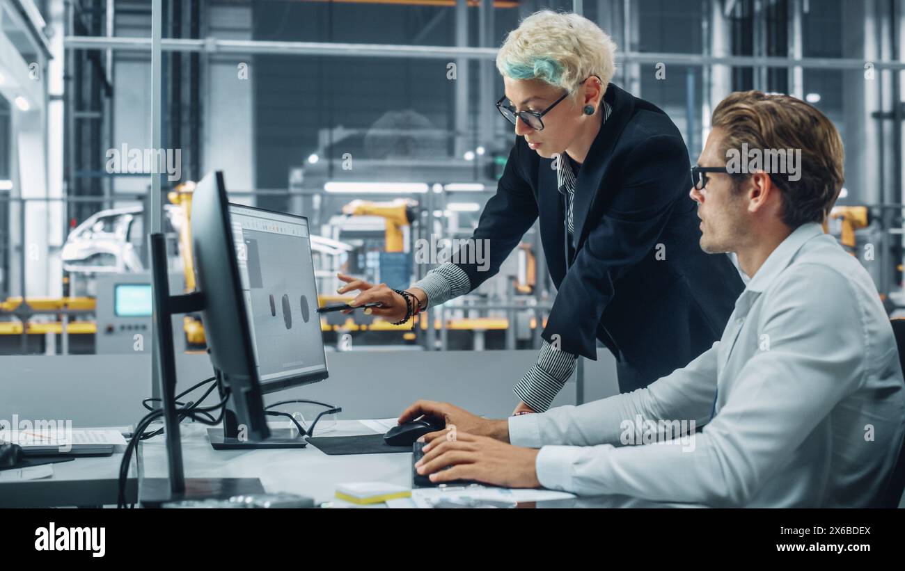 Two Automotive Engineers Discussing Concept Car Blueprints on Desktop ...