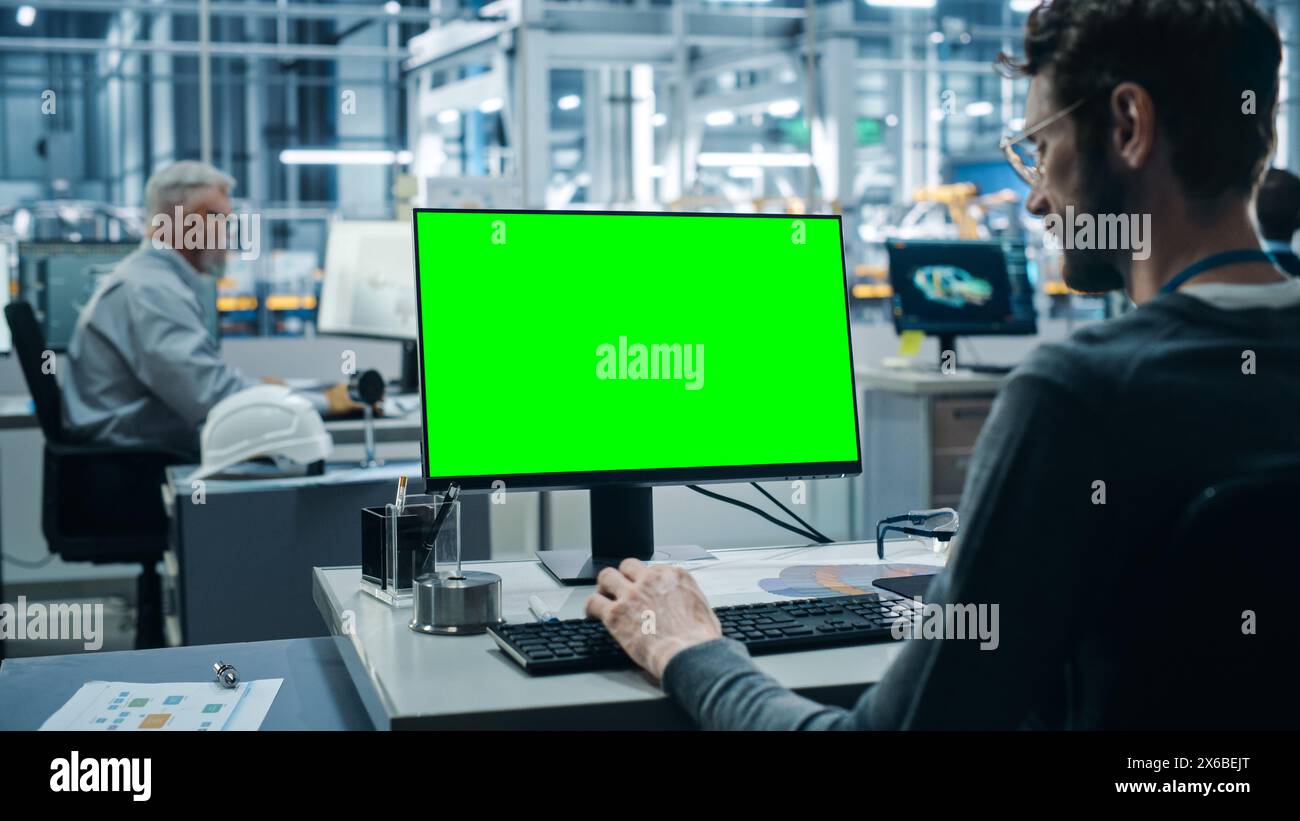 Car Factory Office: Caucasian Male Automotive Engineer Sitting at His ...
