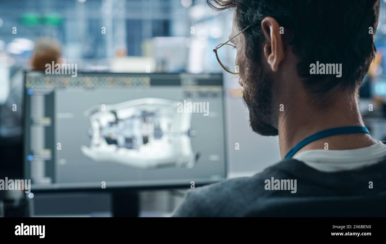 Car Factory Office: Engineer Working on Turbine Prototype on Computer ...