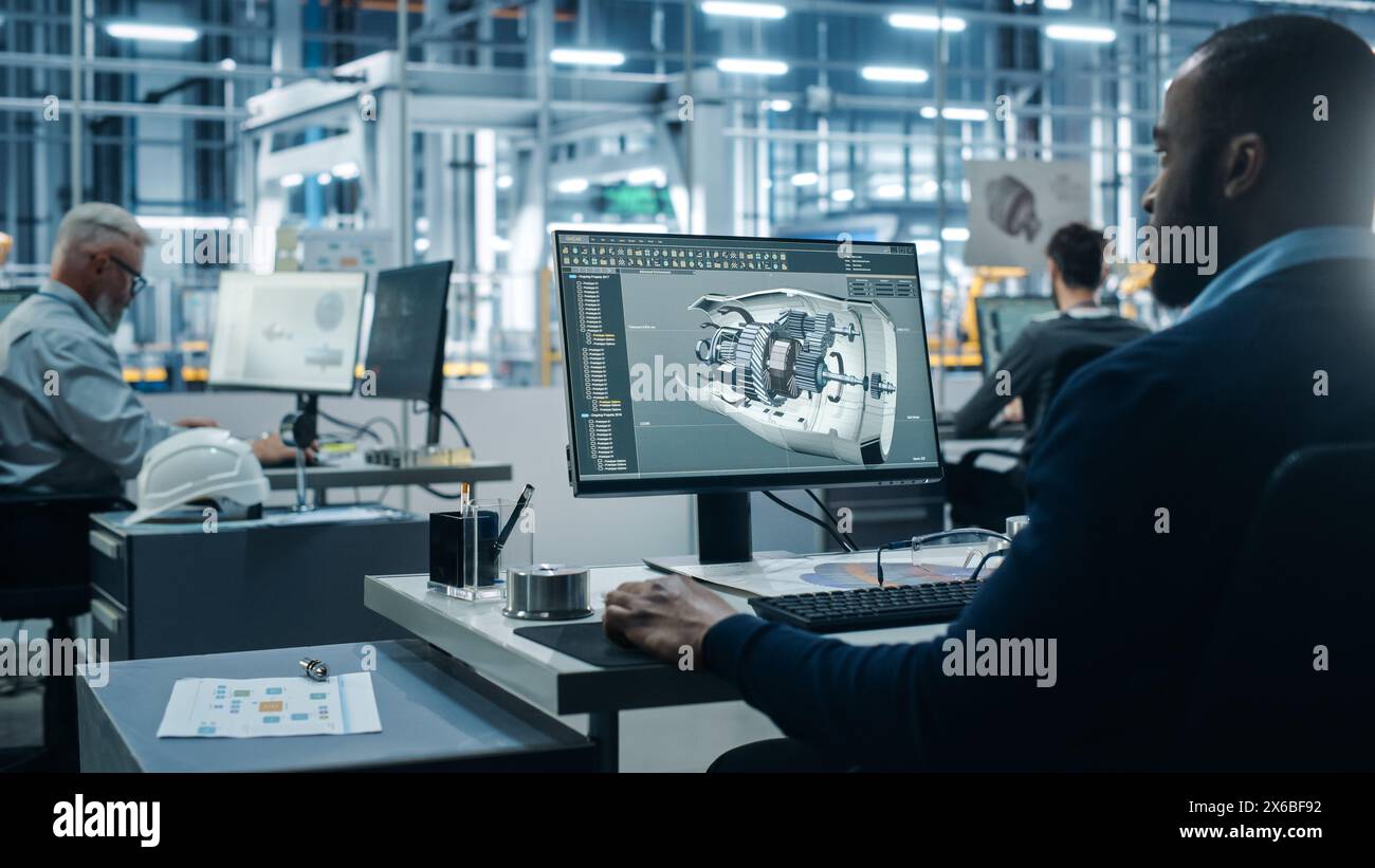 Car Factory Office: Engineer Working on Turbine Prototype on Computer ...