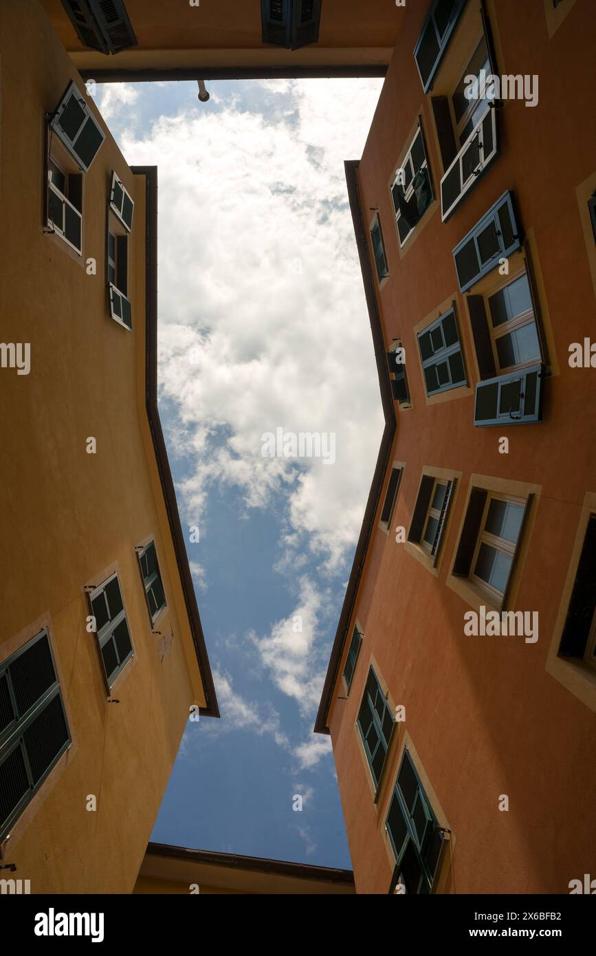 Sky in a gap between houses, bottom view Stock Photo - Alamy