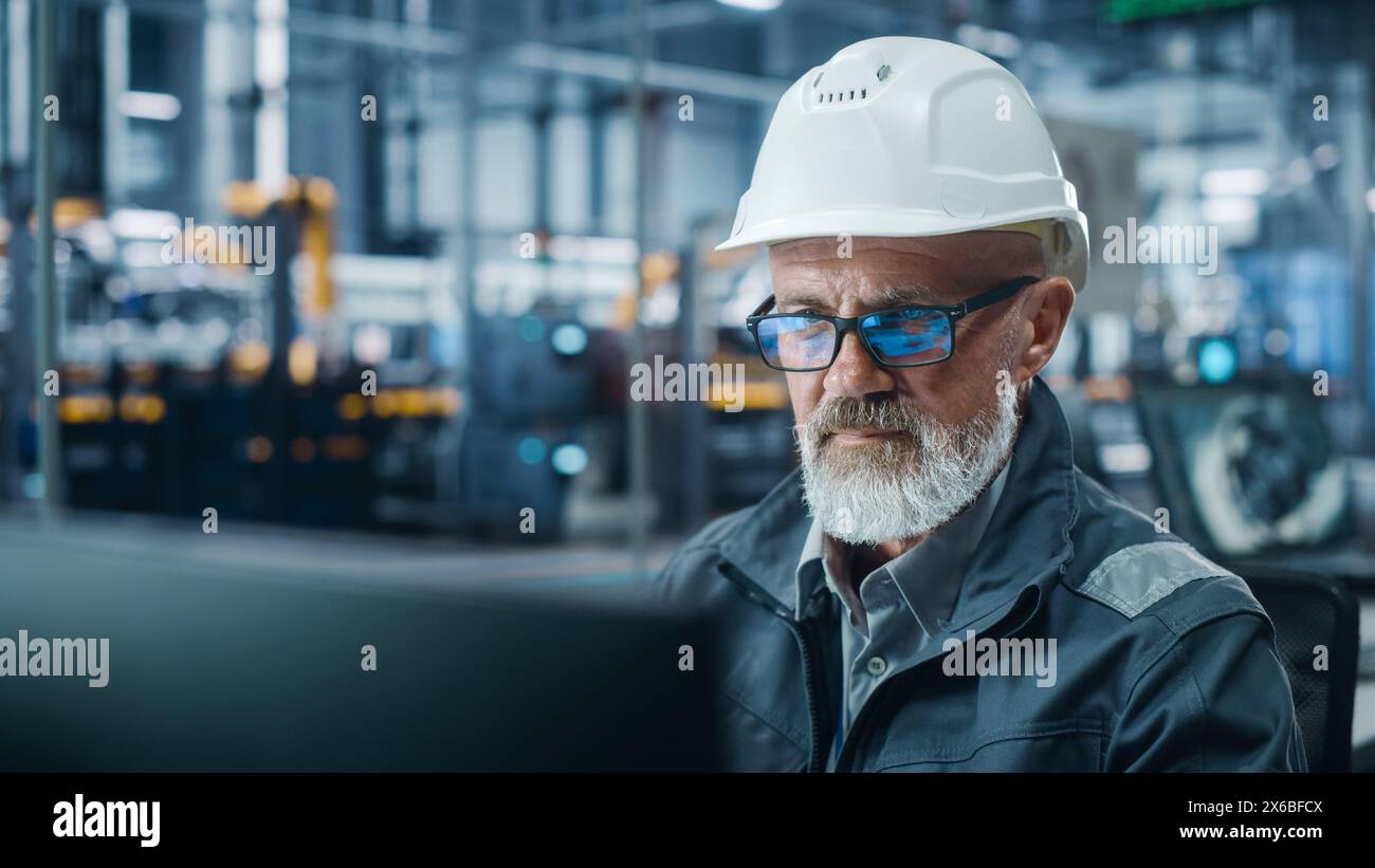 Car Factory Office: Portrait of Male Engineer Working on Computer ...