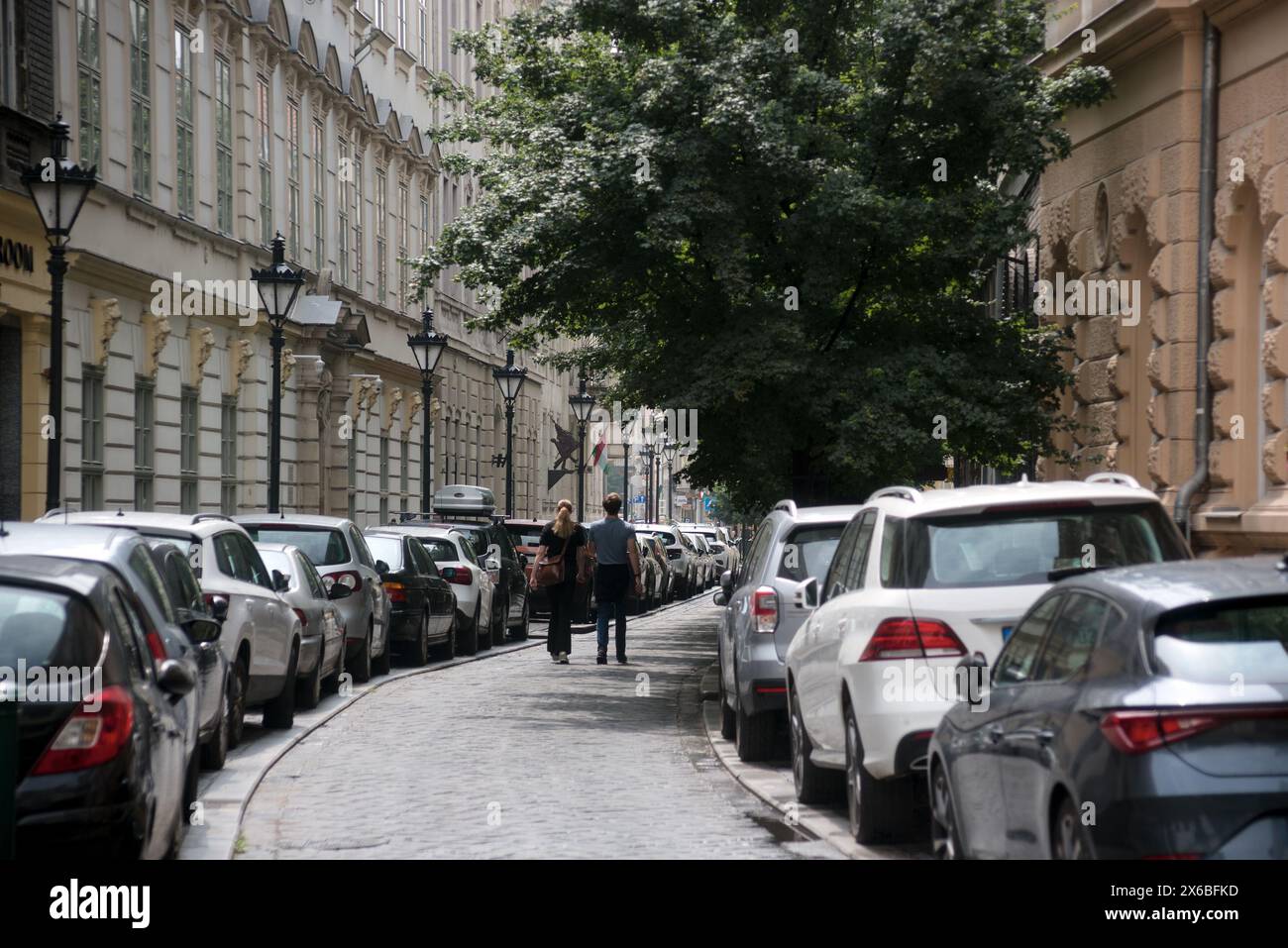 Couple walking in the middle of the street, street sides totally ...