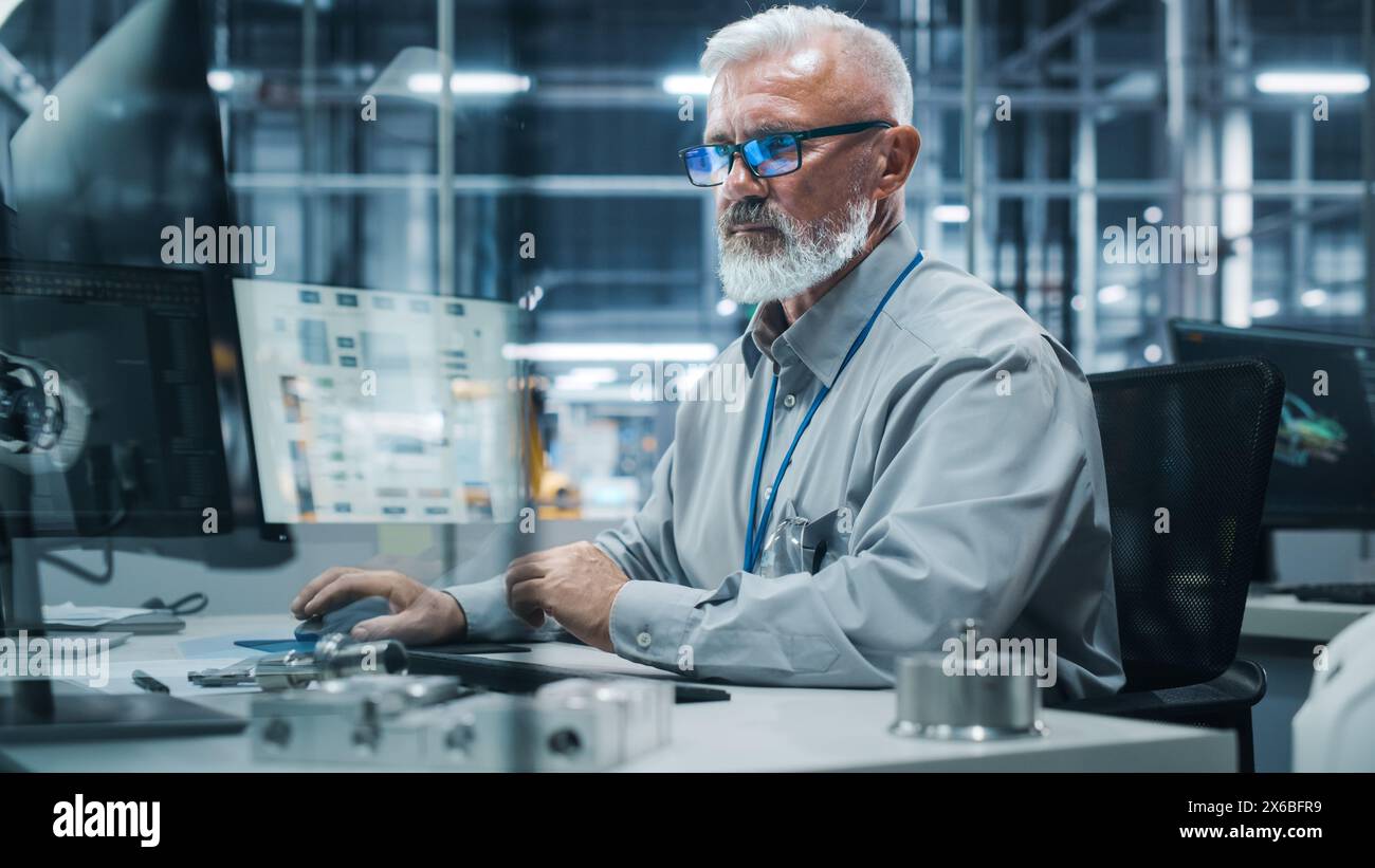 Car Factory Office: Portrait of Senior Male Chief Engineer Working on ...