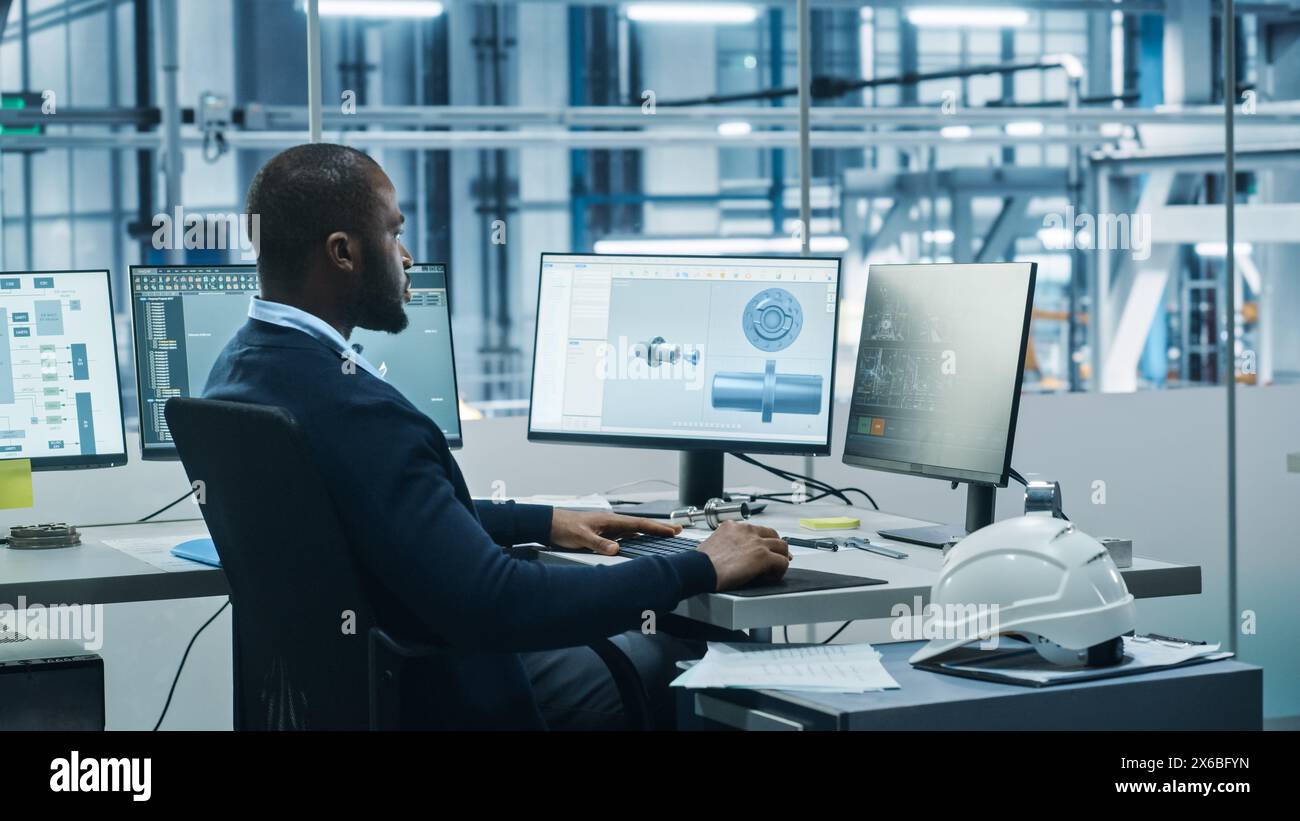Car Factory Office: Black Engineer Working on Desktop Computer, Screens ...