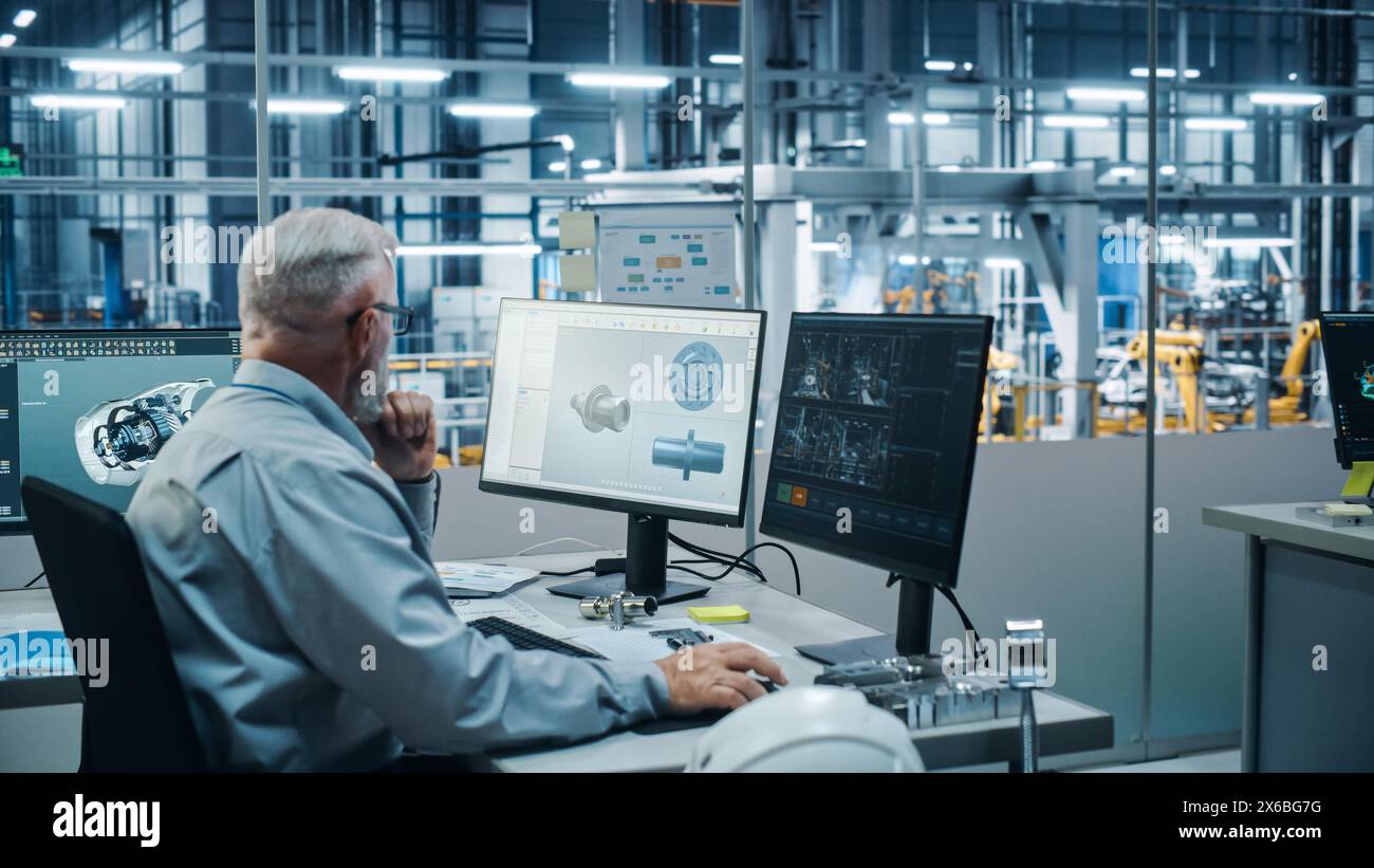 Car Factory Office: Male Chief Automotive Engineer Sitting at His Desk ...