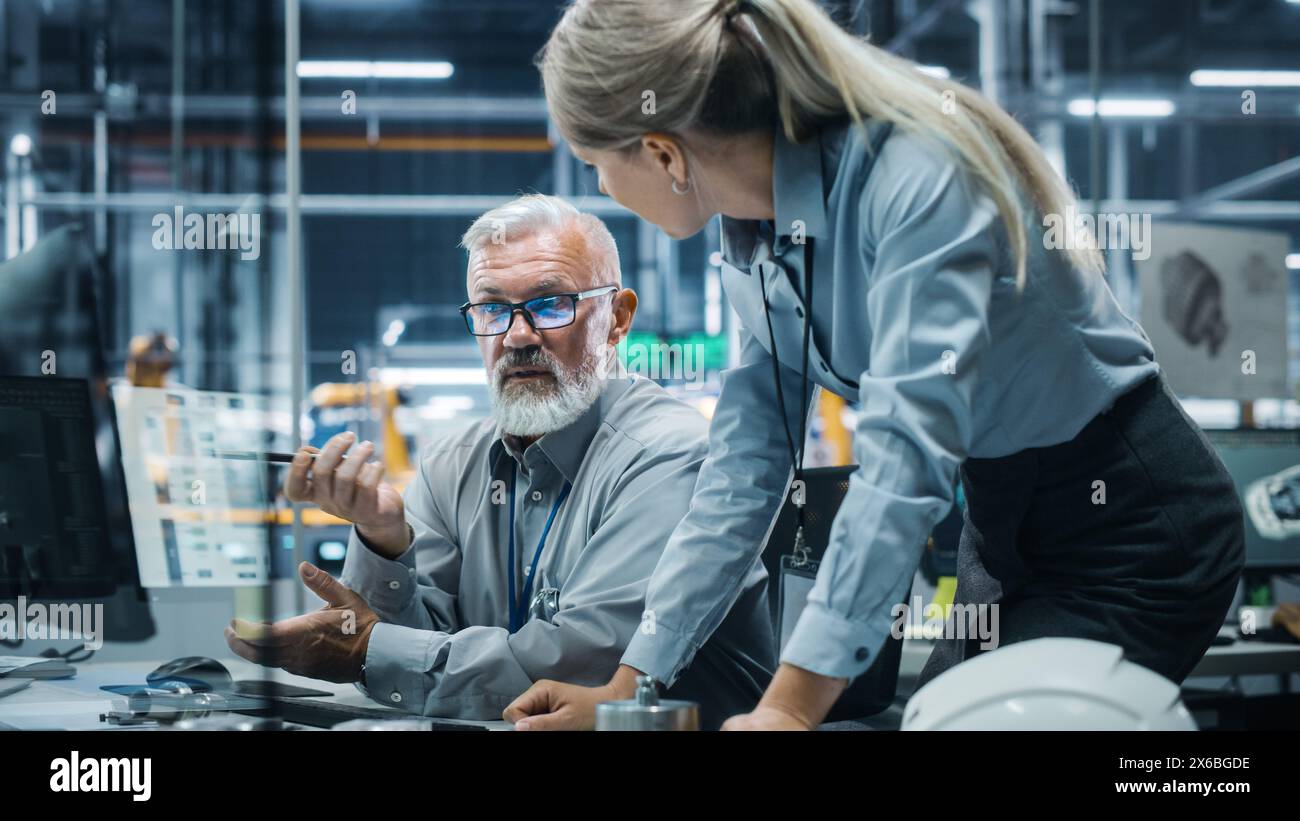 Car Factory Office: Manager Talks to Engineer Working on Computer. CAD ...