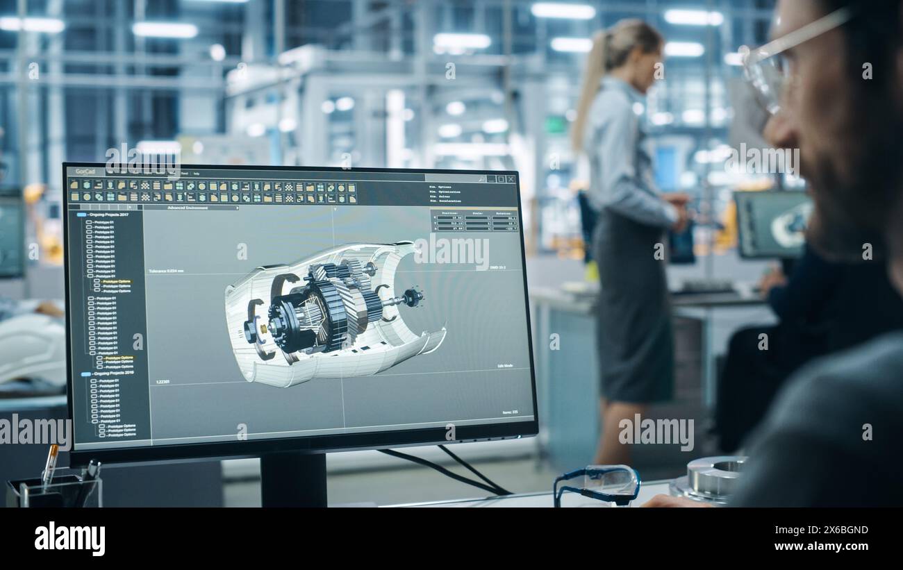 Car Factory Office: Engineer Working on Turbine Prototype on Computer ...