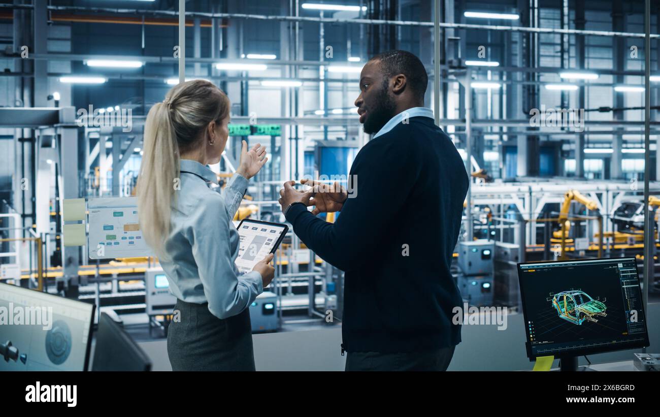 Car Factory Office: Female Engineer Talks with Male Scientist, Use ...