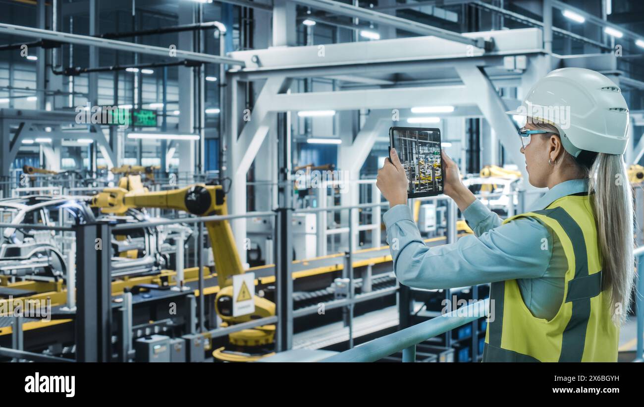 Car Factory Female Automotive Engineer Using Augmented Reality Tablet Computer Digitalization