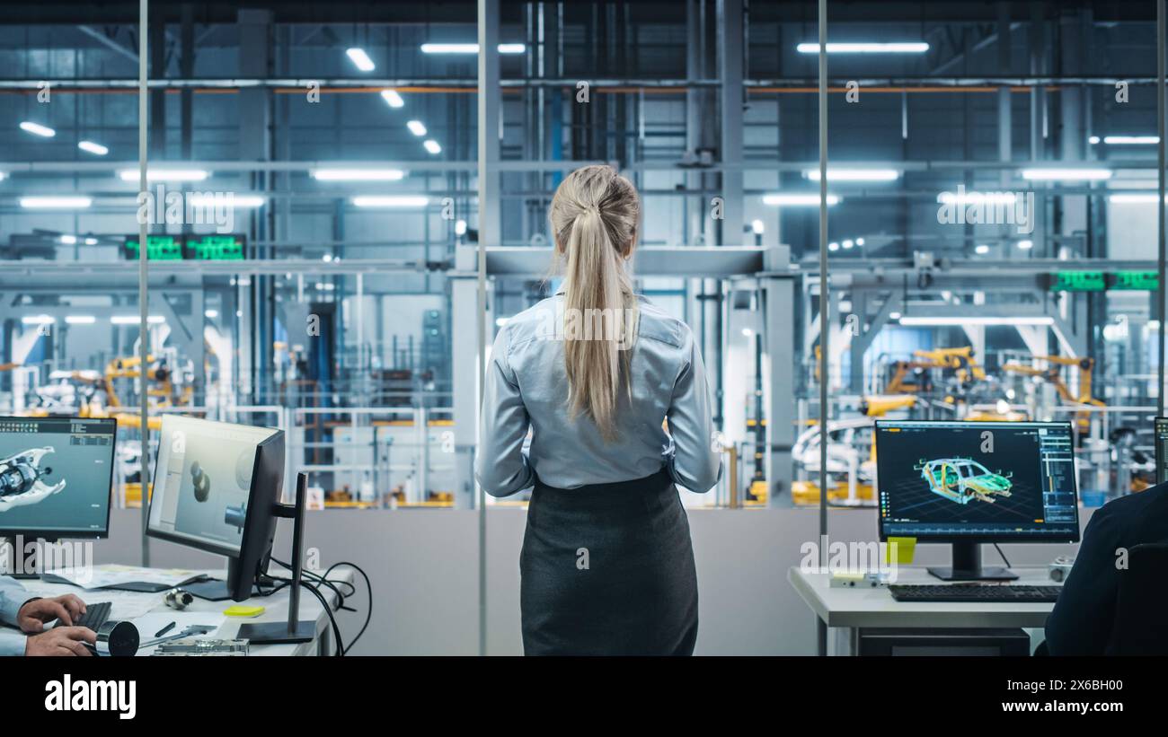Car Factory Office: Successful Female Chief Engineer Overlooking ...